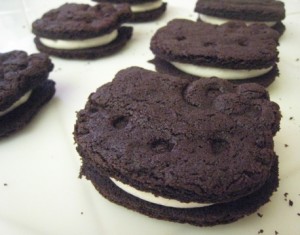 Using a piping bag, pipe the filling onto the backs of the cookies ...