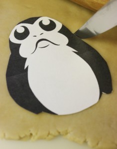 Roll out the dough to about 1/4 inch thick. Use the porg template to ...